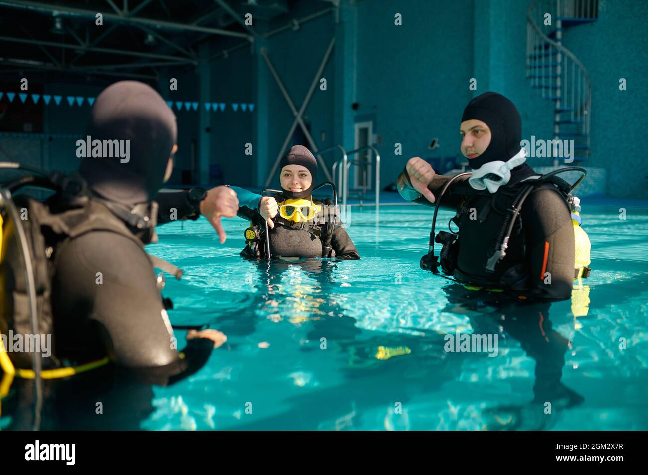 Instructor and two divers, lesson in diving school Stock Photo - Alamy