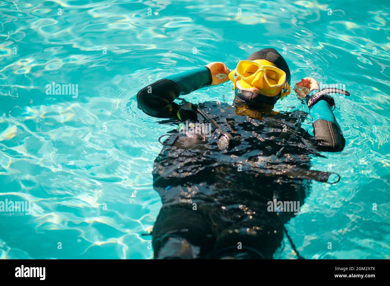 Female diver in scuba gear poses in pool, top view Stock Photo - Alamy