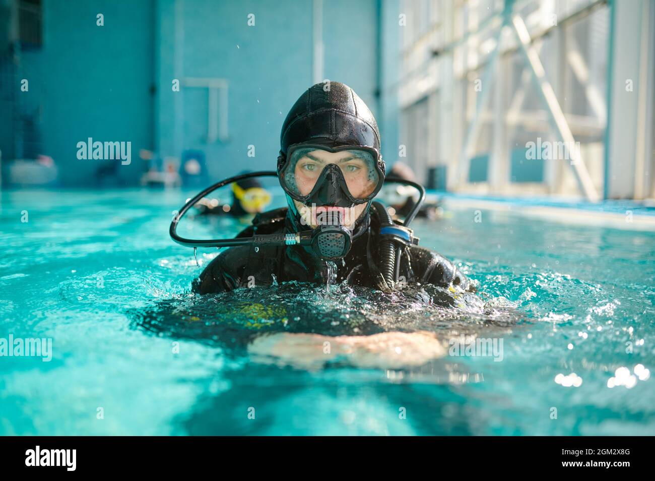Male diver in scuba gear and mask poses in pool Stock Photo - Alamy