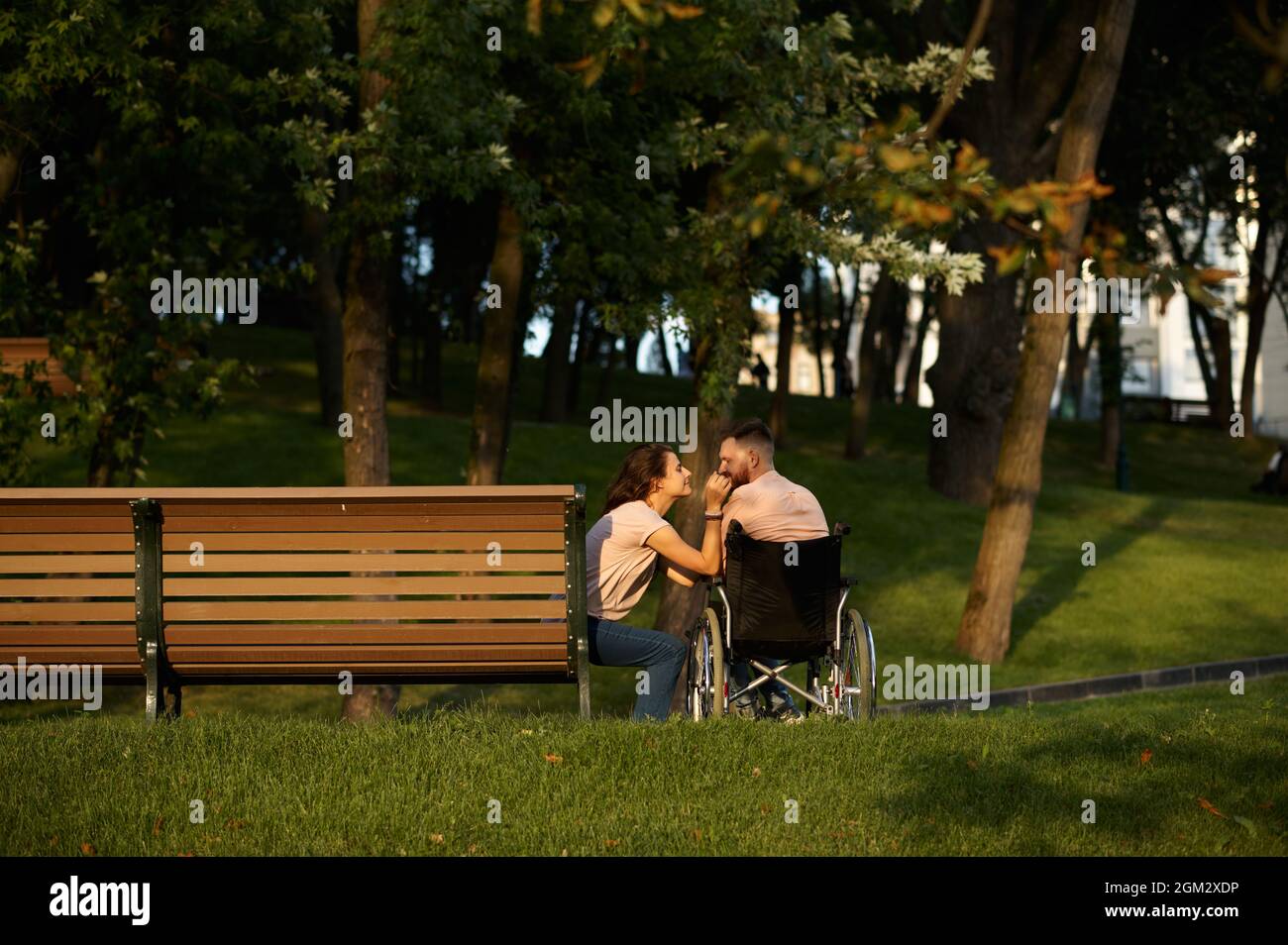 Love couple, care for disabled man in wheelchair Stock Photo - Alamy