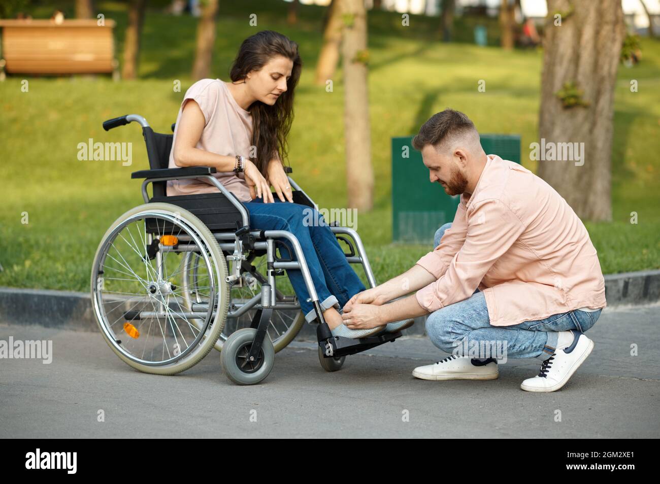 Love couple, care for disabled woman in wheelchair Stock Photo - Alamy