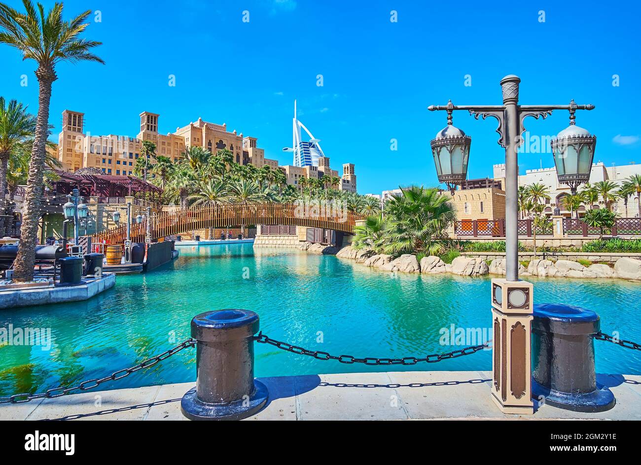Souk Madinat Jumeirah market has a canal with a pedestrian bridge, Fort ...