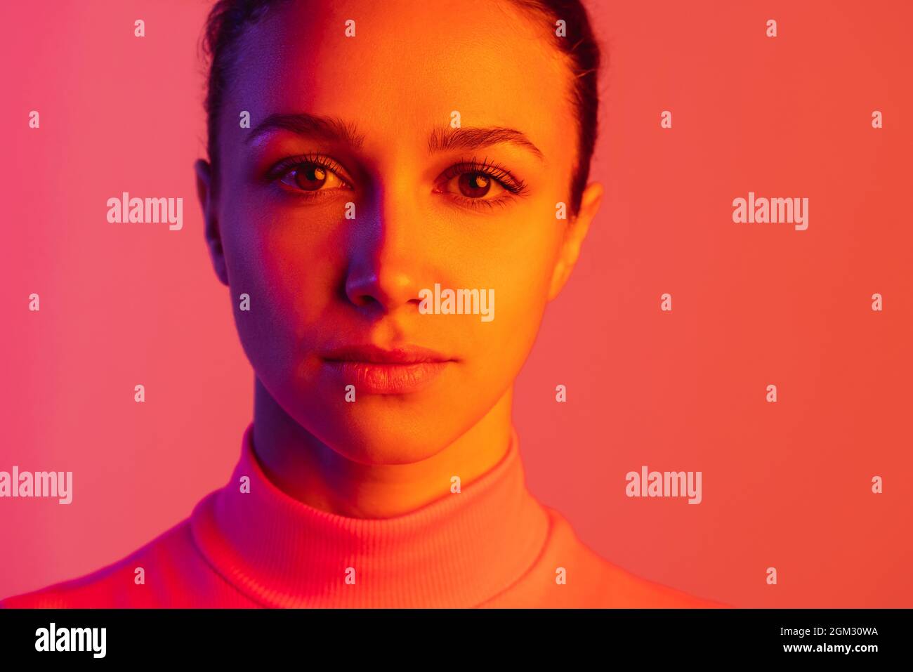Cropped close-up portrait of young beautiful girl deeply looking on ...