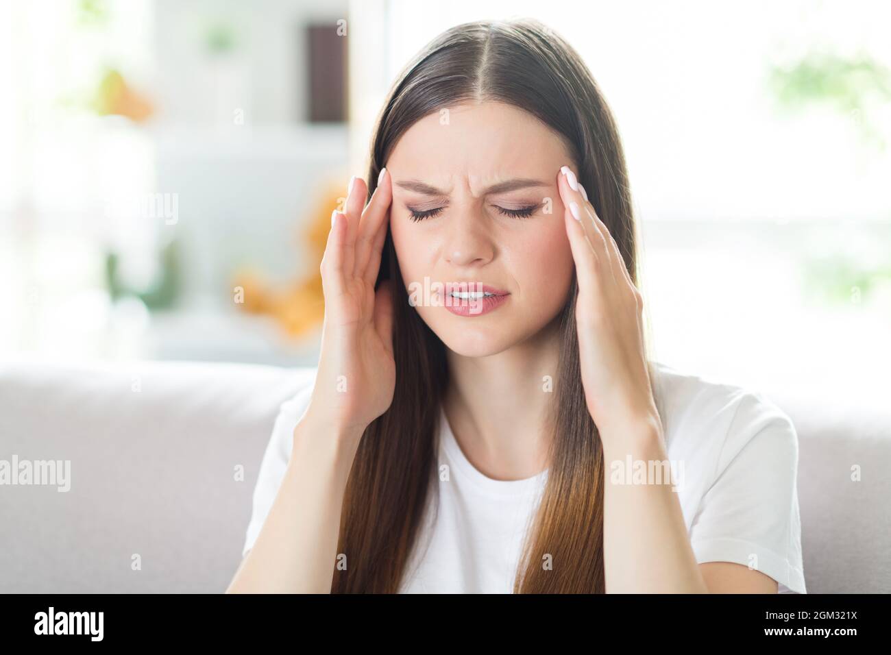 Portrait of attractive depressed frustrated brown-haired girl touching ...
