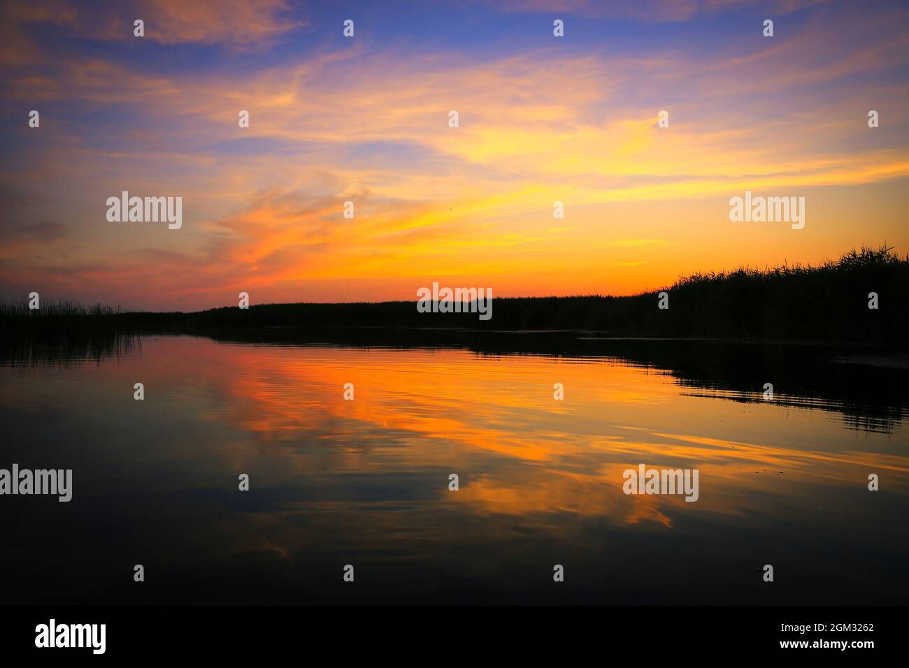 evening landscape with evening sky over lake water surface Stock Photo ...