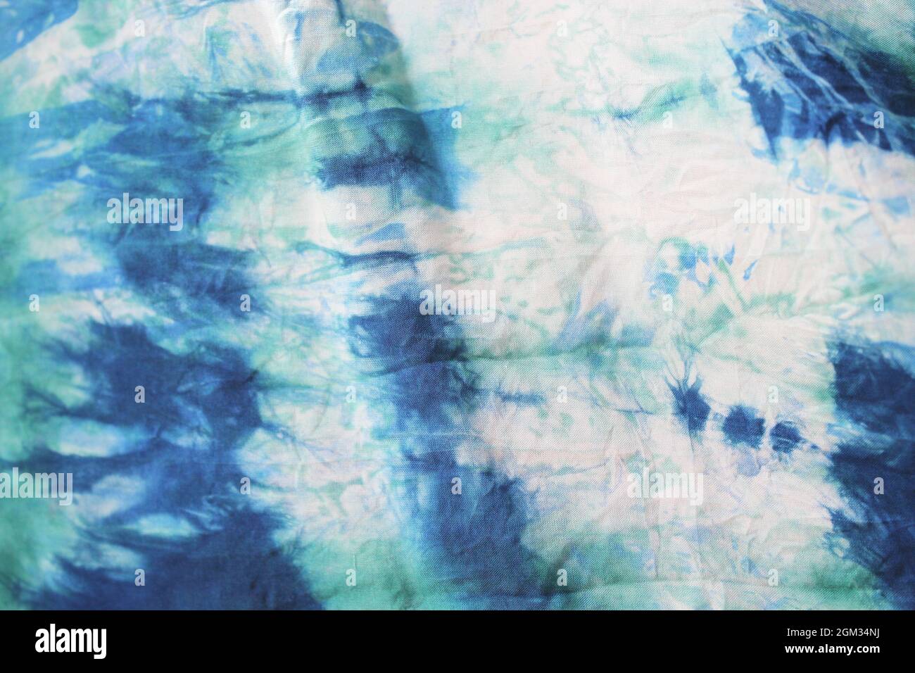 Tie dye green background with half circle layers of dye pattern fading ...