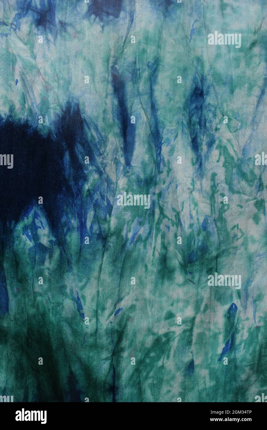 Tie dye green background with half circle layers of dye pattern fading ...