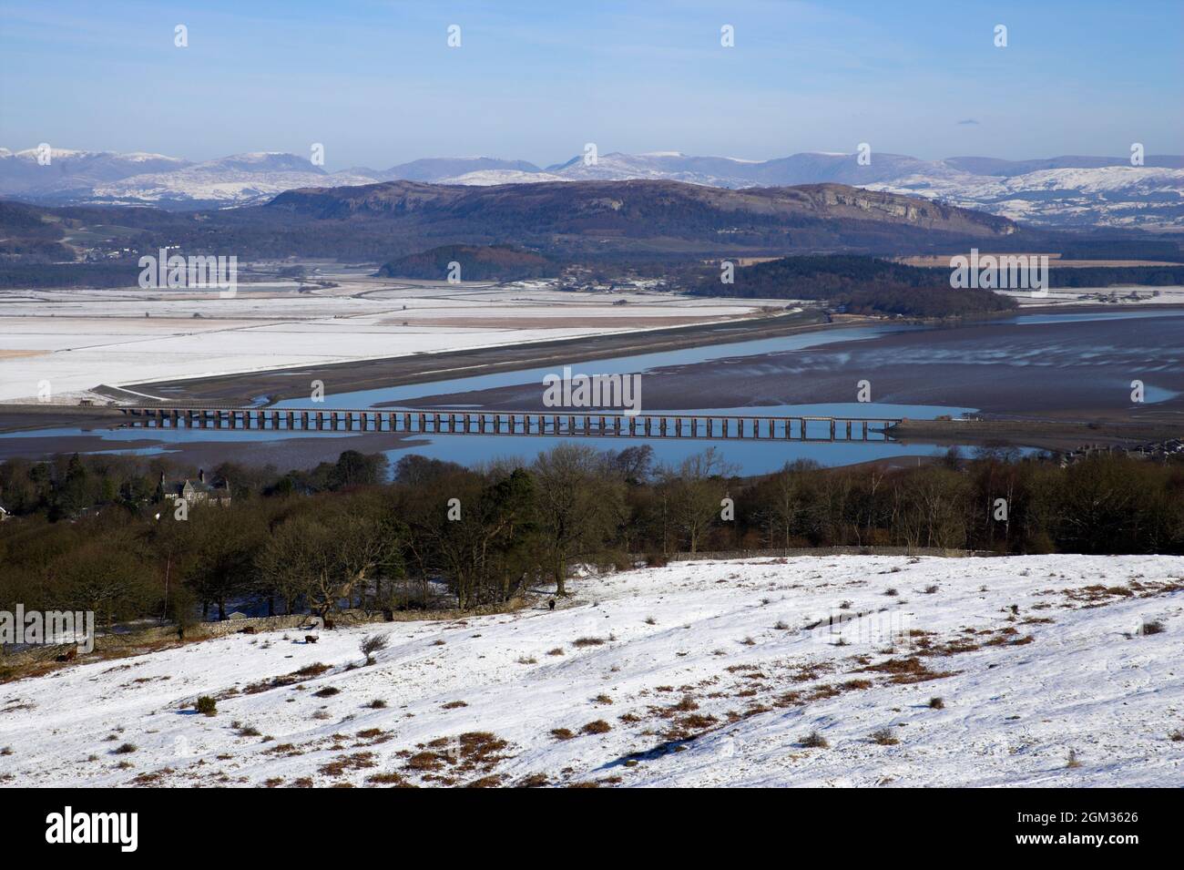 View of Lakeland fells and Kent estuary from Arnside Knott in snow ...