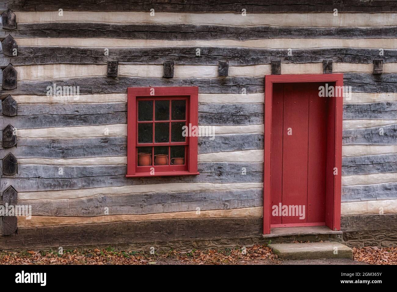 Country Log Cabin - Close view to log cabin details with a red door and ...