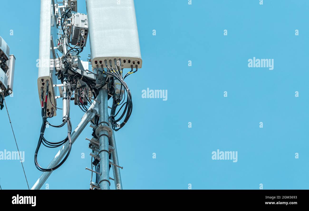 Telecommunication tower with clear blue sky background. The antenna against the blue sky. Radio ...