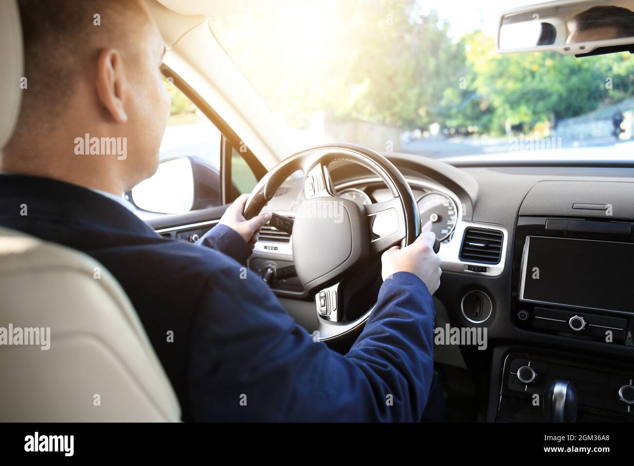 Man in formal wear on driver's seat of car Stock Photo - Alamy