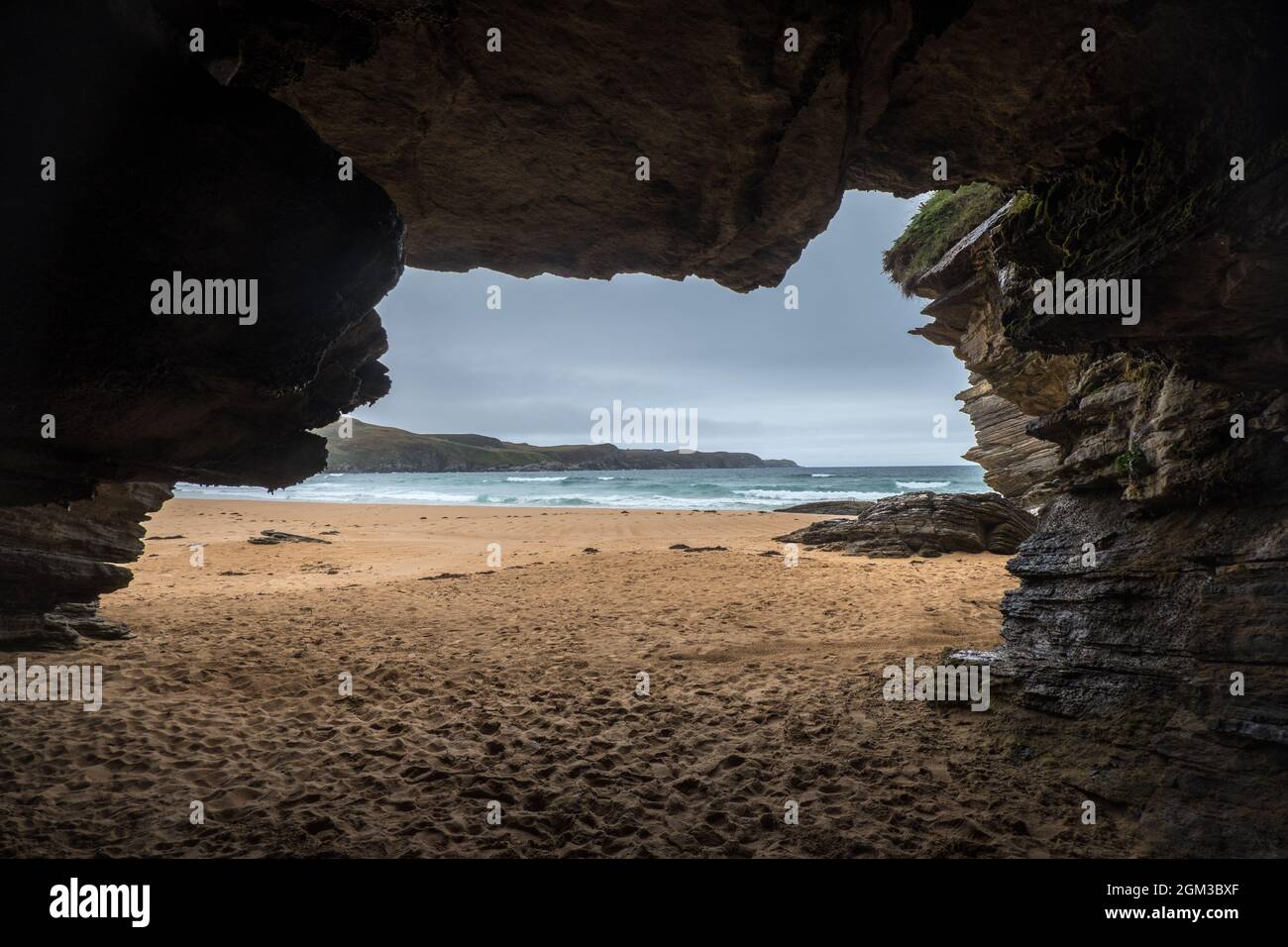 View from inside cave at Strathy Bay Stock Photo - Alamy