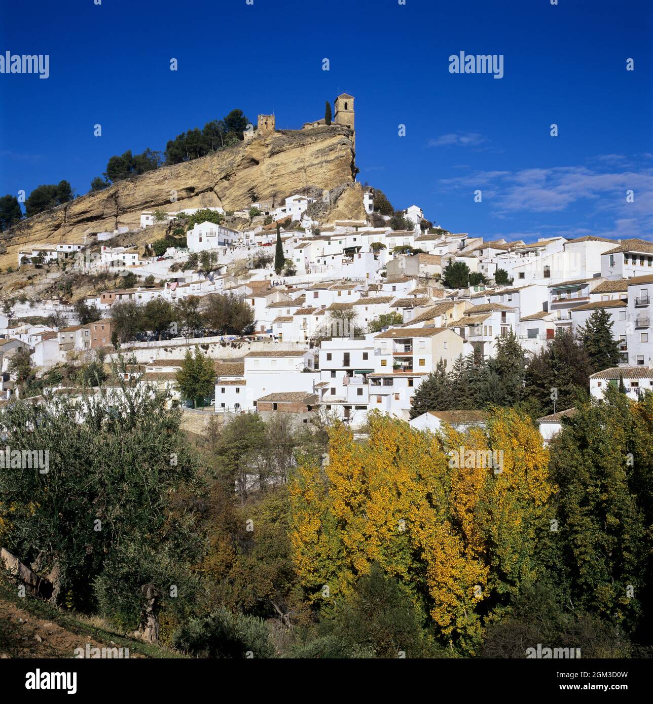 Church on top of crag overlooking the white village in autumn ...