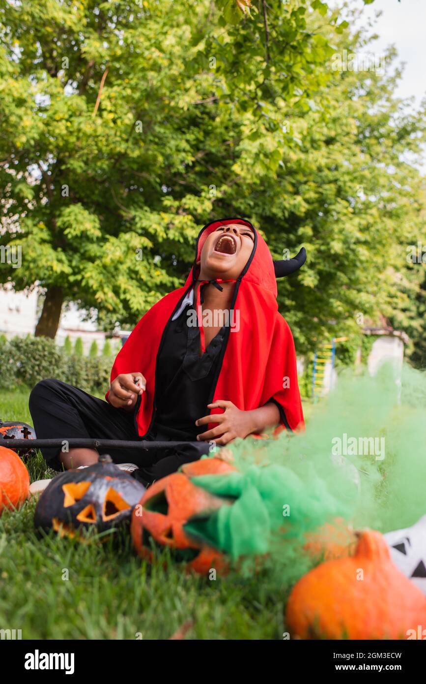 scary african american kid in devil halloween costume laughing loud ...