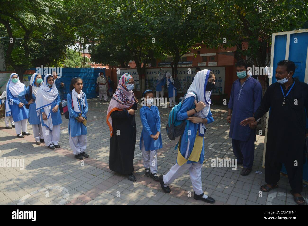 Pakistani students are coming out from school after holidays on the ...