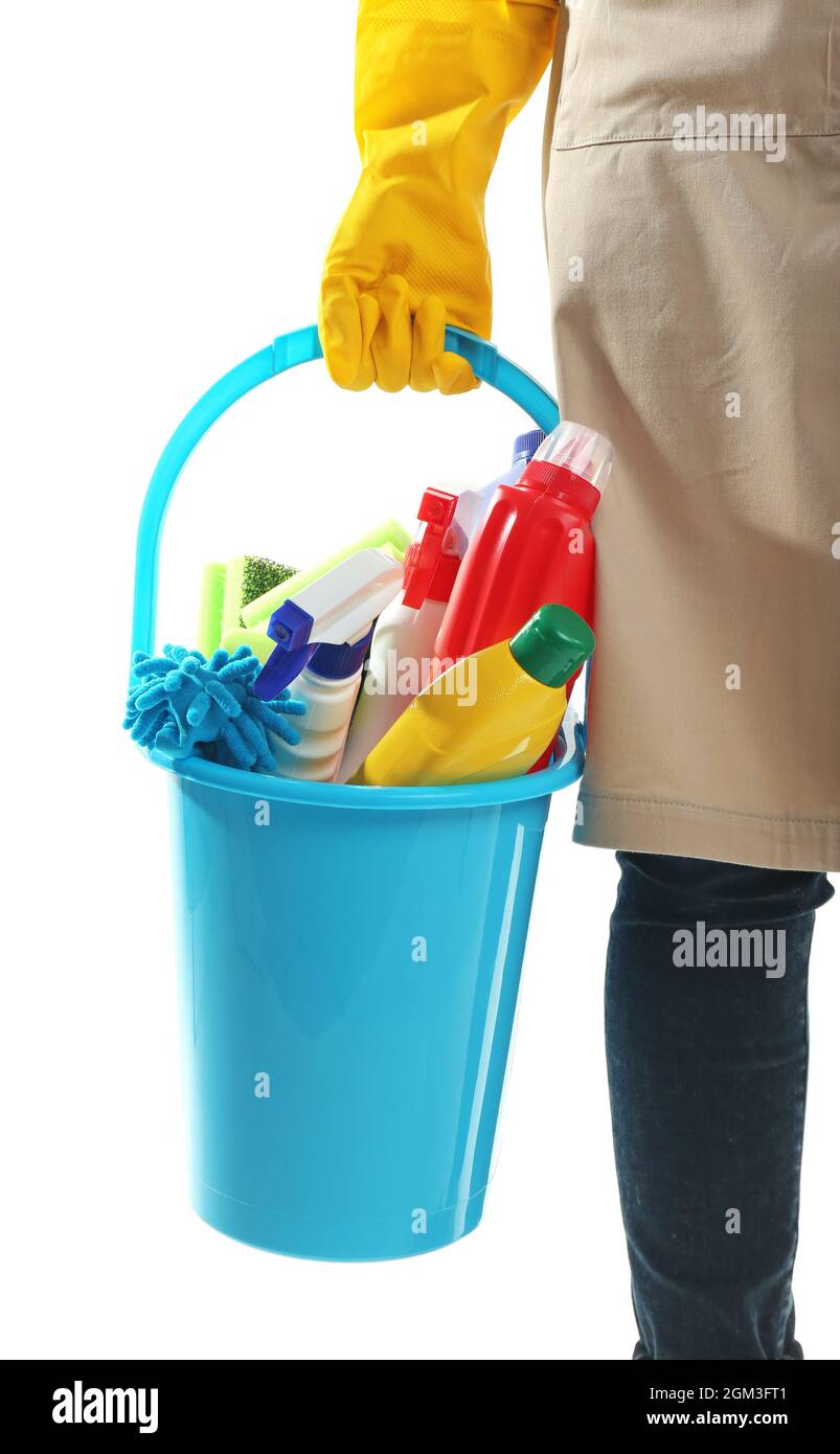 Woman holding bucket with cleaning products and tools on white ...