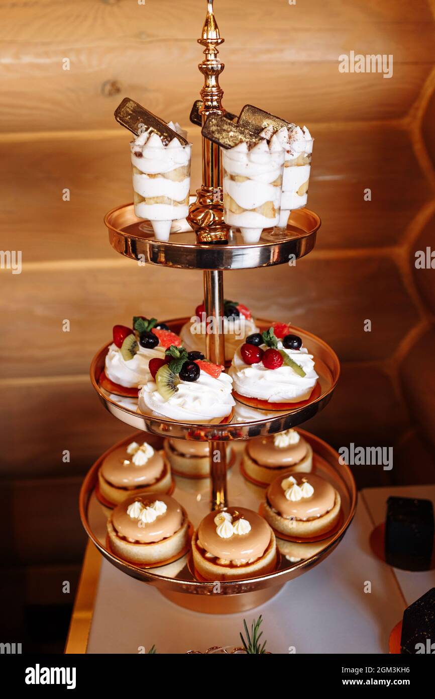 luxury wedding catering, table with modern desserts, cupcakes, sweets ...