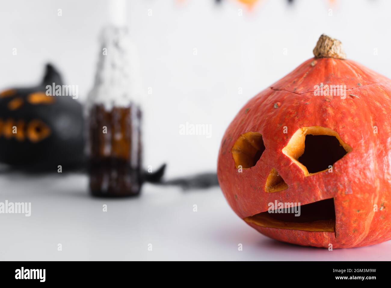 carved and creepy pumpkin on white table Stock Photo - Alamy