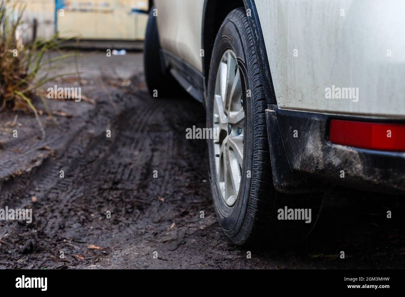 wheels of a white car in the mud Stock Photo - Alamy