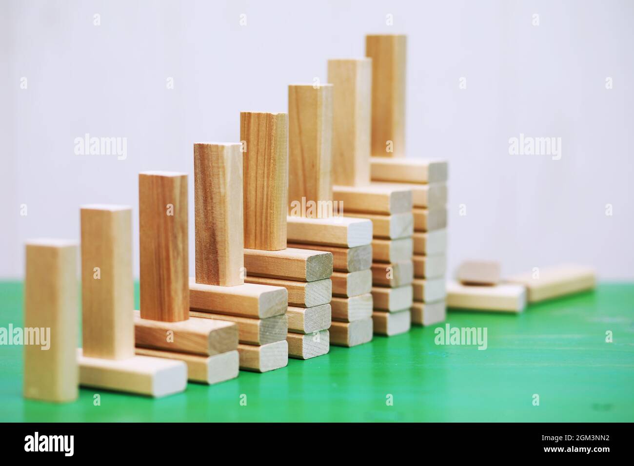 Stick wood block standing on stacked square wood blocks, abstract ...