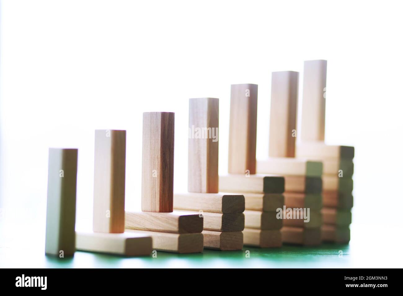 Stick wood block standing on stacked square wood blocks, abstract ...