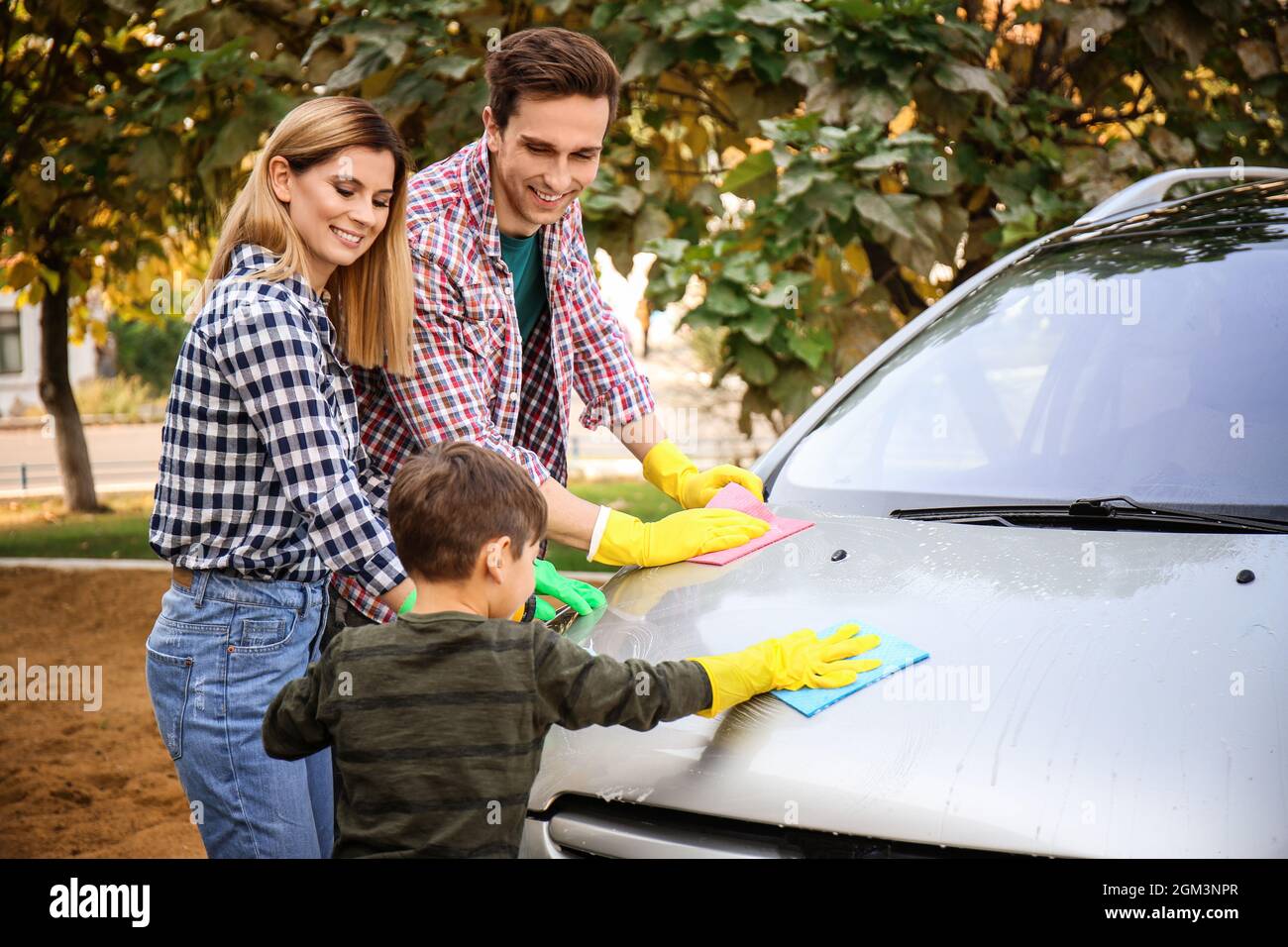 Young couple washing car together hi-res stock photography and images ...