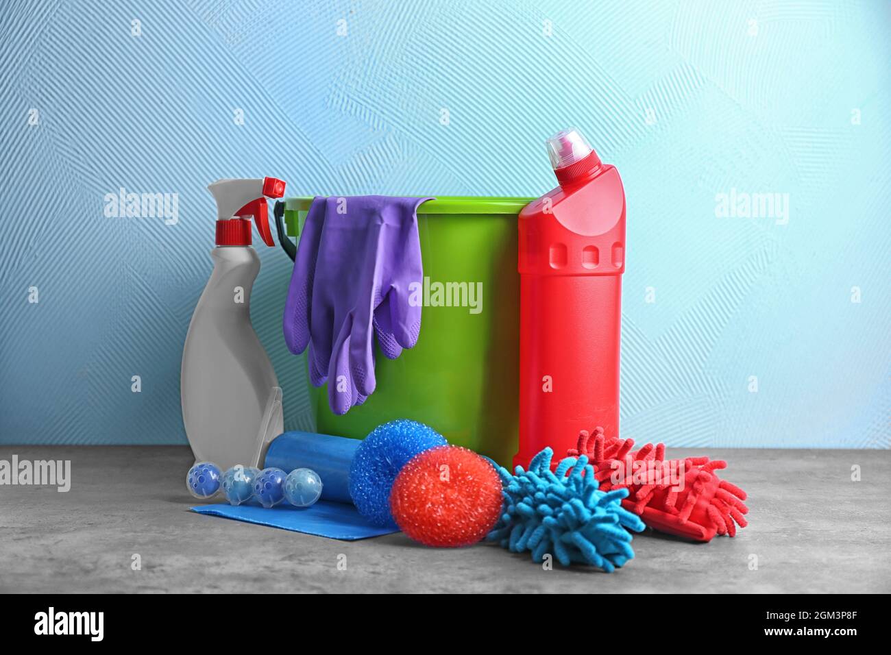 Cleaning supplies on color background Stock Photo - Alamy
