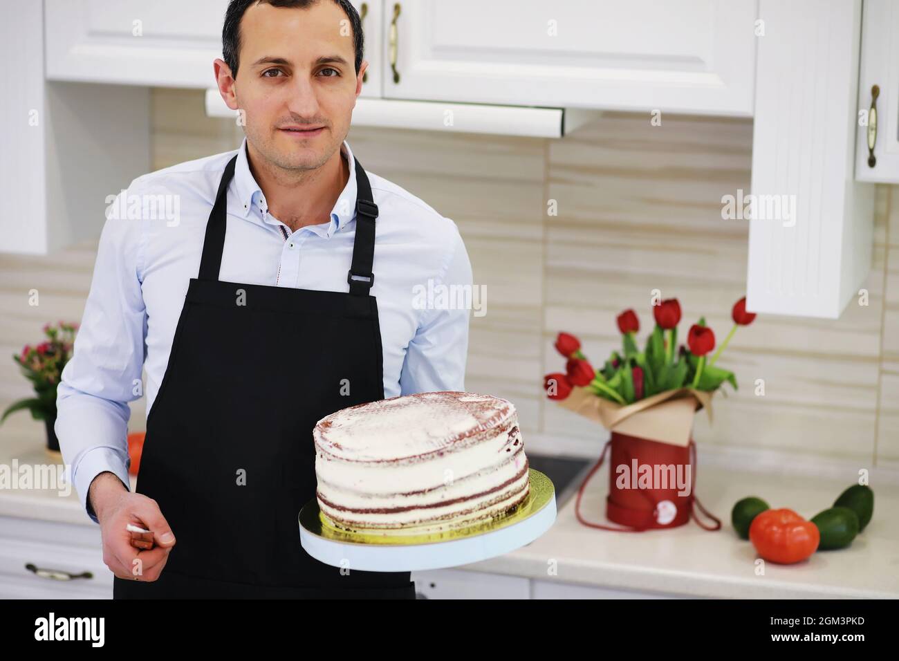 Master pastry chef in front of a desk. Cooking desserts at home. The ...