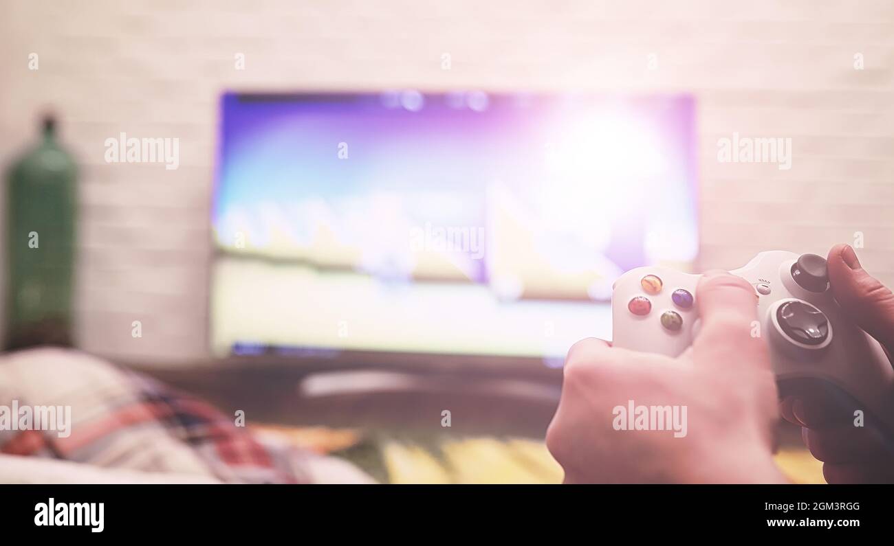 Playing on the console. Man is playing a game while lying on the floor ...