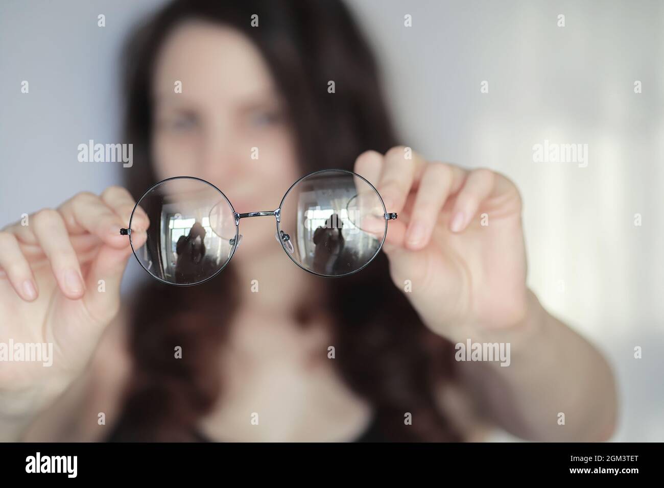 The concept of poor vision. Hold a contact lens and glasses in hand ...
