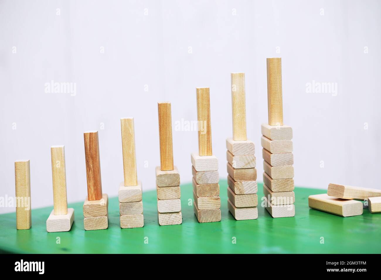 Stick wood block standing on stacked square wood blocks, abstract ...
