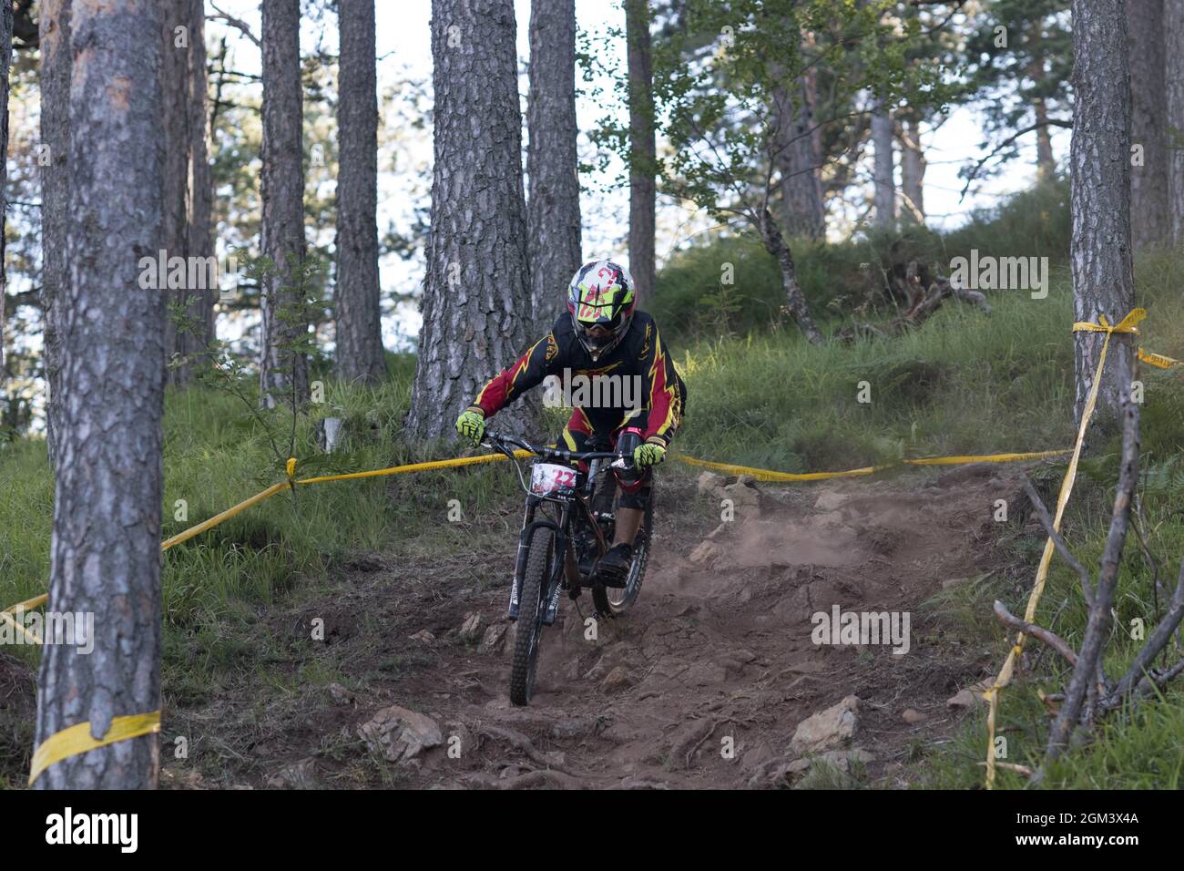 A young downhill driver on steep terrain during a race Stock Photo - Alamy