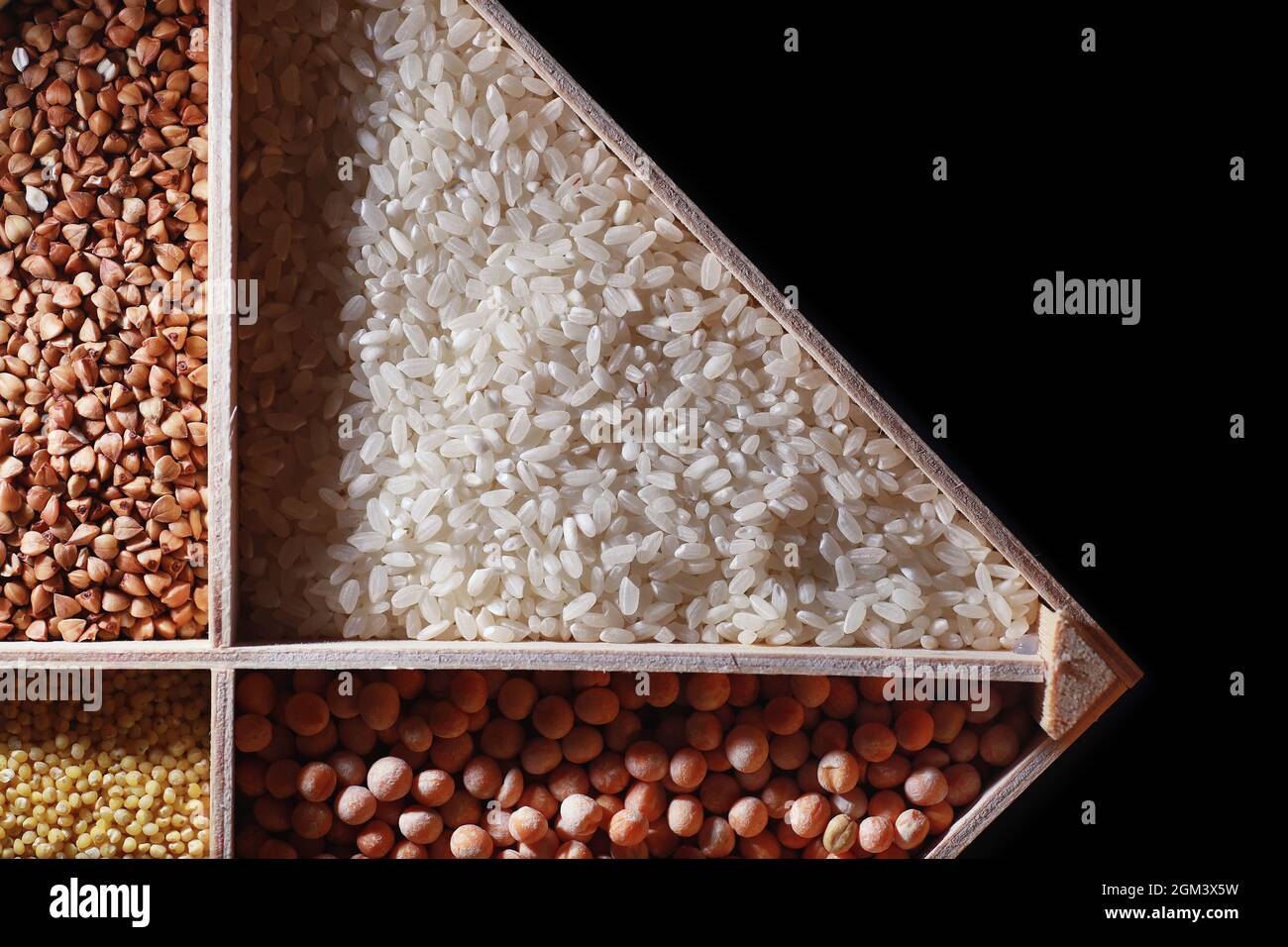 A set of grain cereals. Rice, buckwheat and millet groats in wooden ...