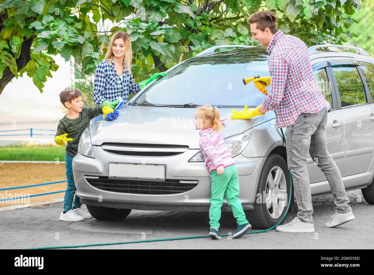 Young couple washing car together hi-res stock photography and images ...