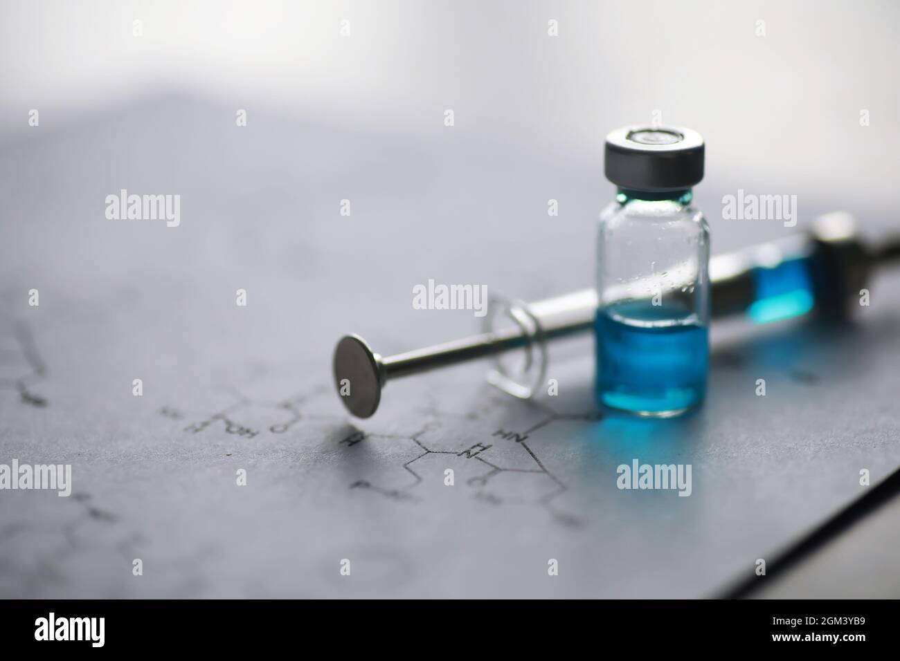 small jars with injection and syringe for injection on blue background ...