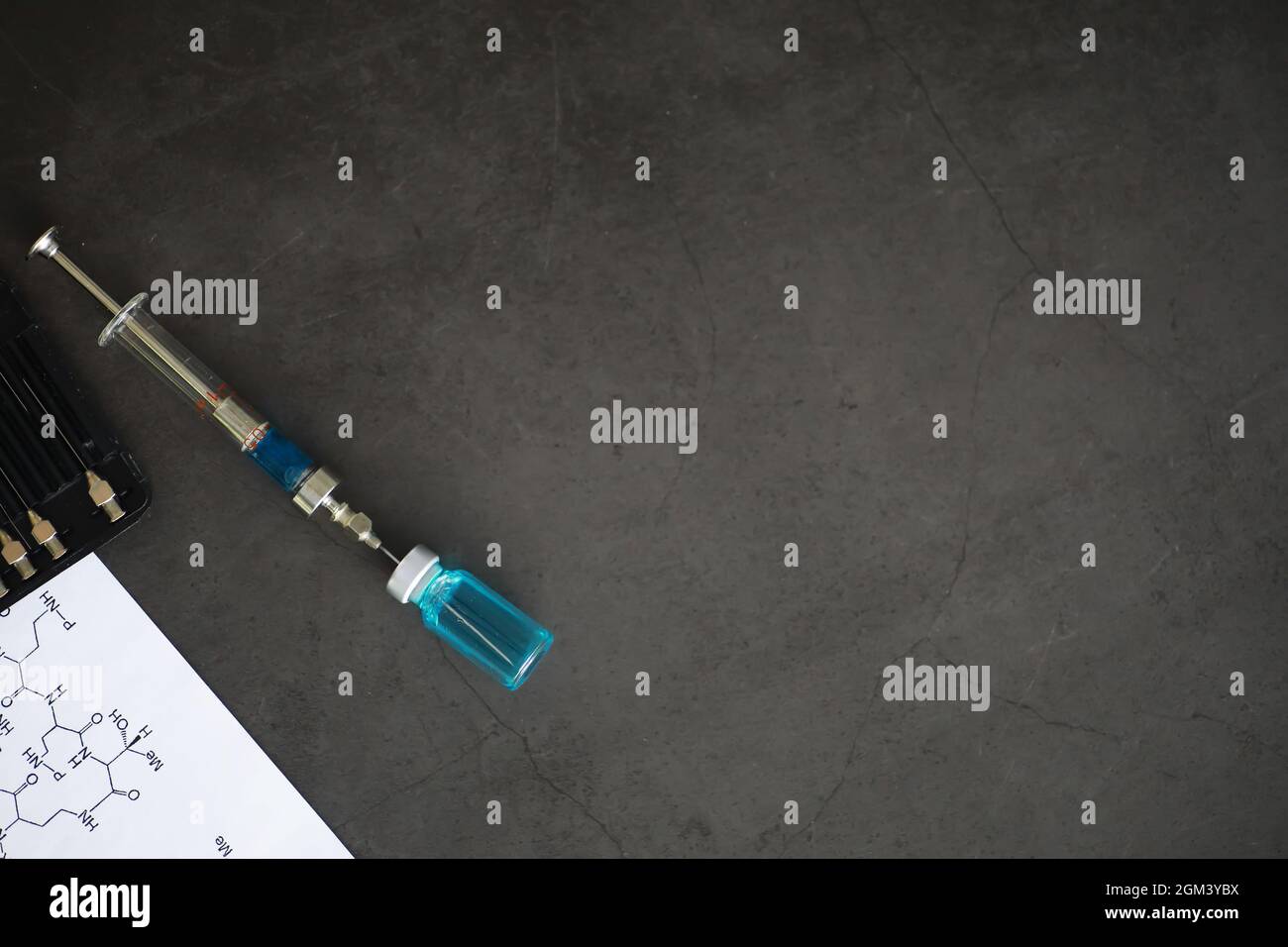 small jars with injection and syringe for injection on blue background ...