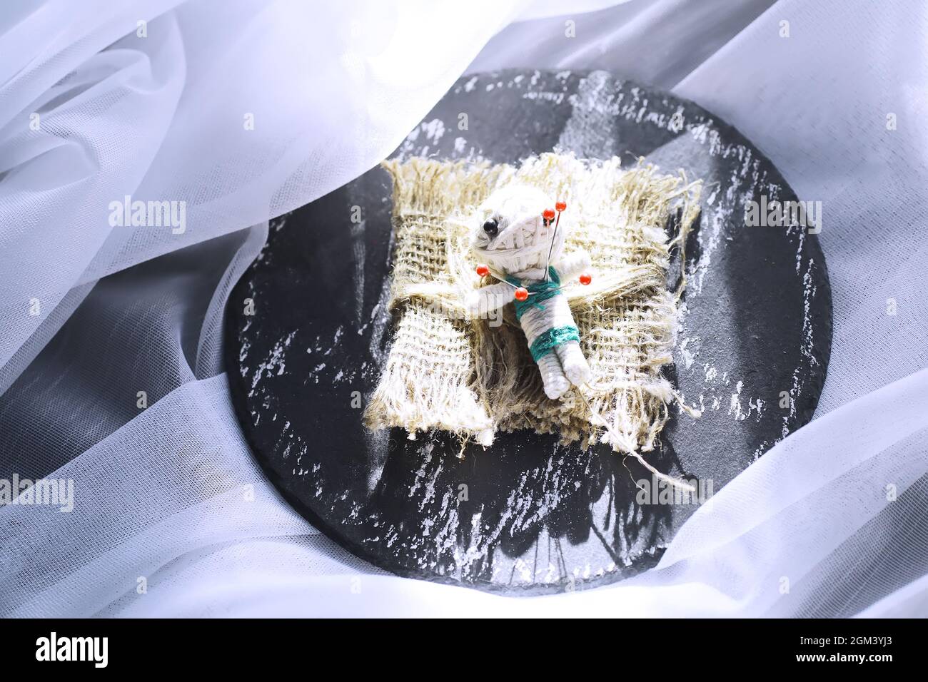 Voodoo Doll on a stone background with dramatic lighting. Mystic still ...