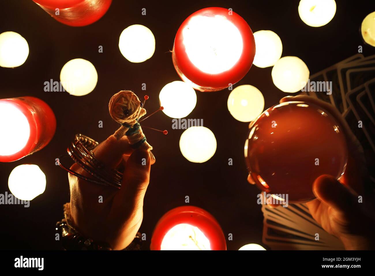 Mystic still life with voodoo doll, the tarot cards, books, evil ...