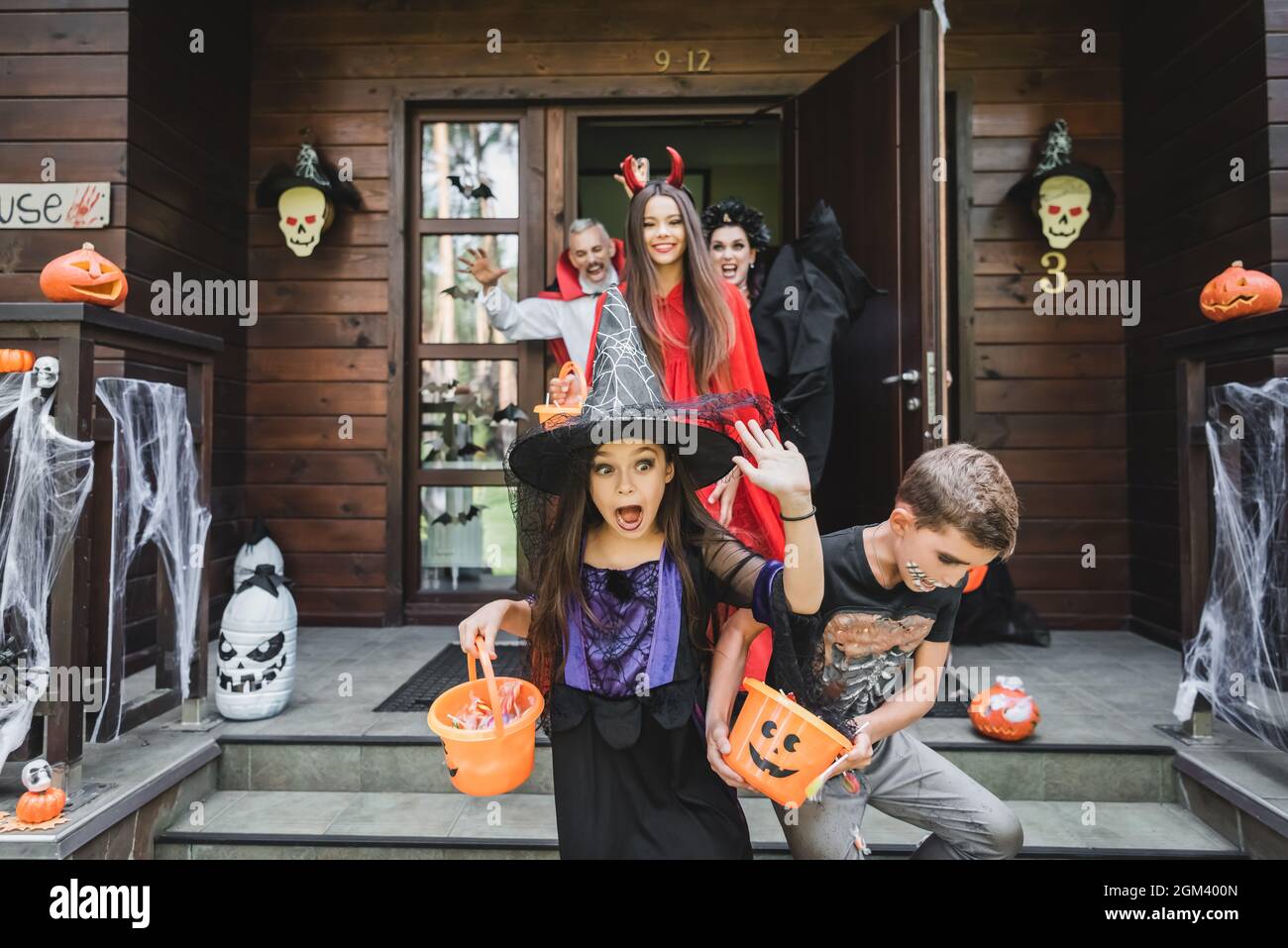 scared girl in halloween costume screaming while running out house from ...