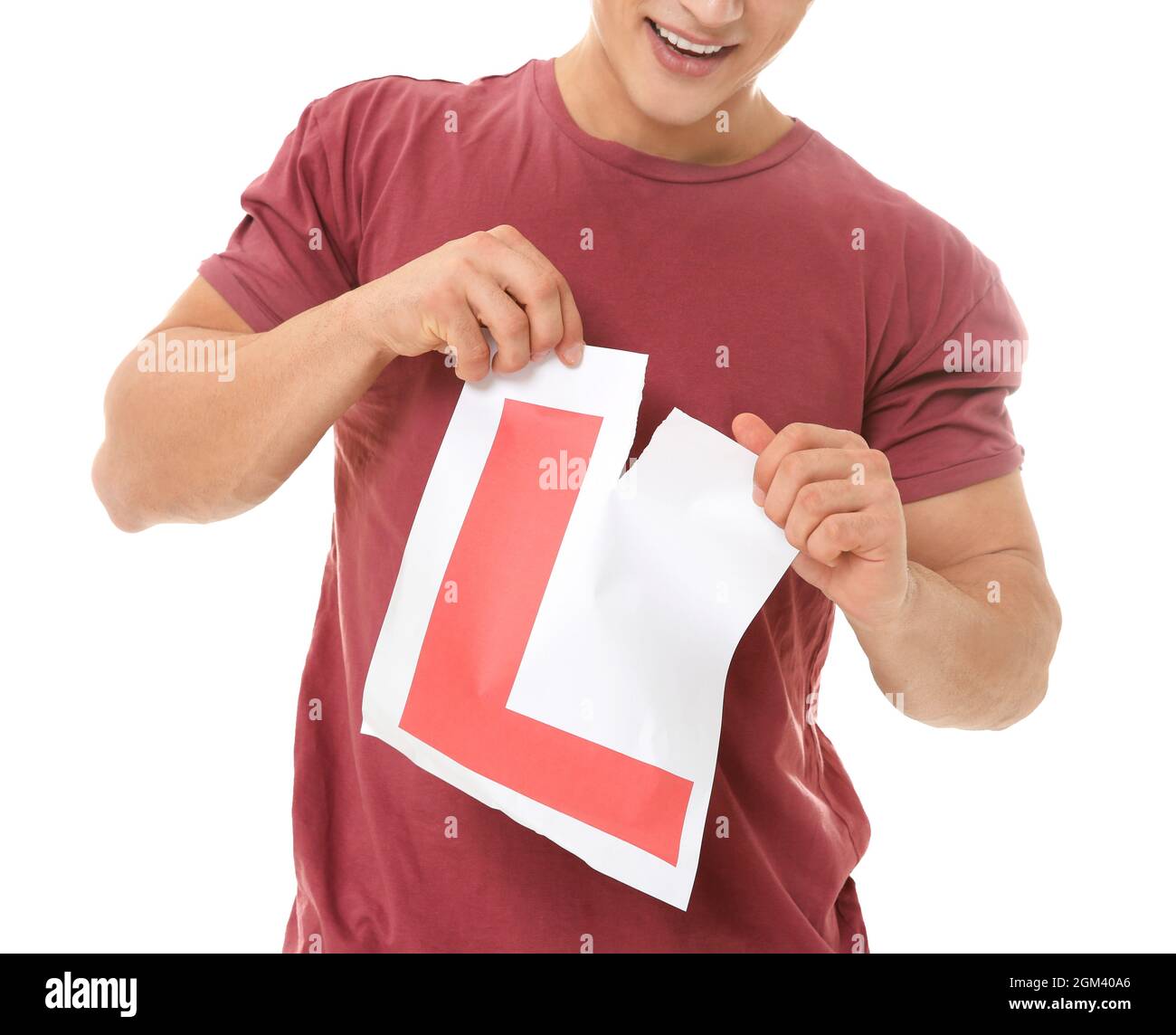Young man tearing learner driver sign on white background Stock Photo ...