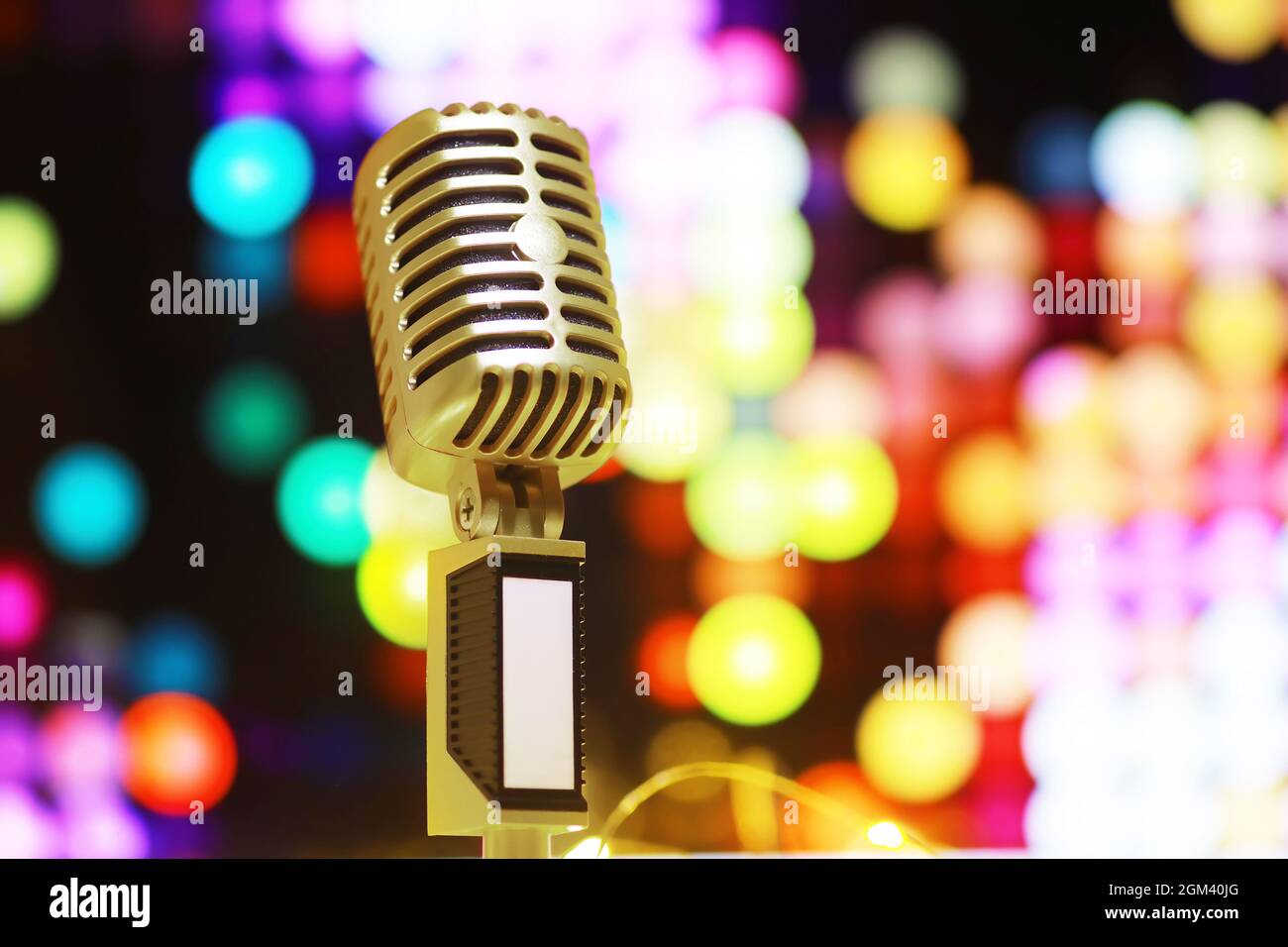 Retro style microphone on background with backlight. Vintage silver ...