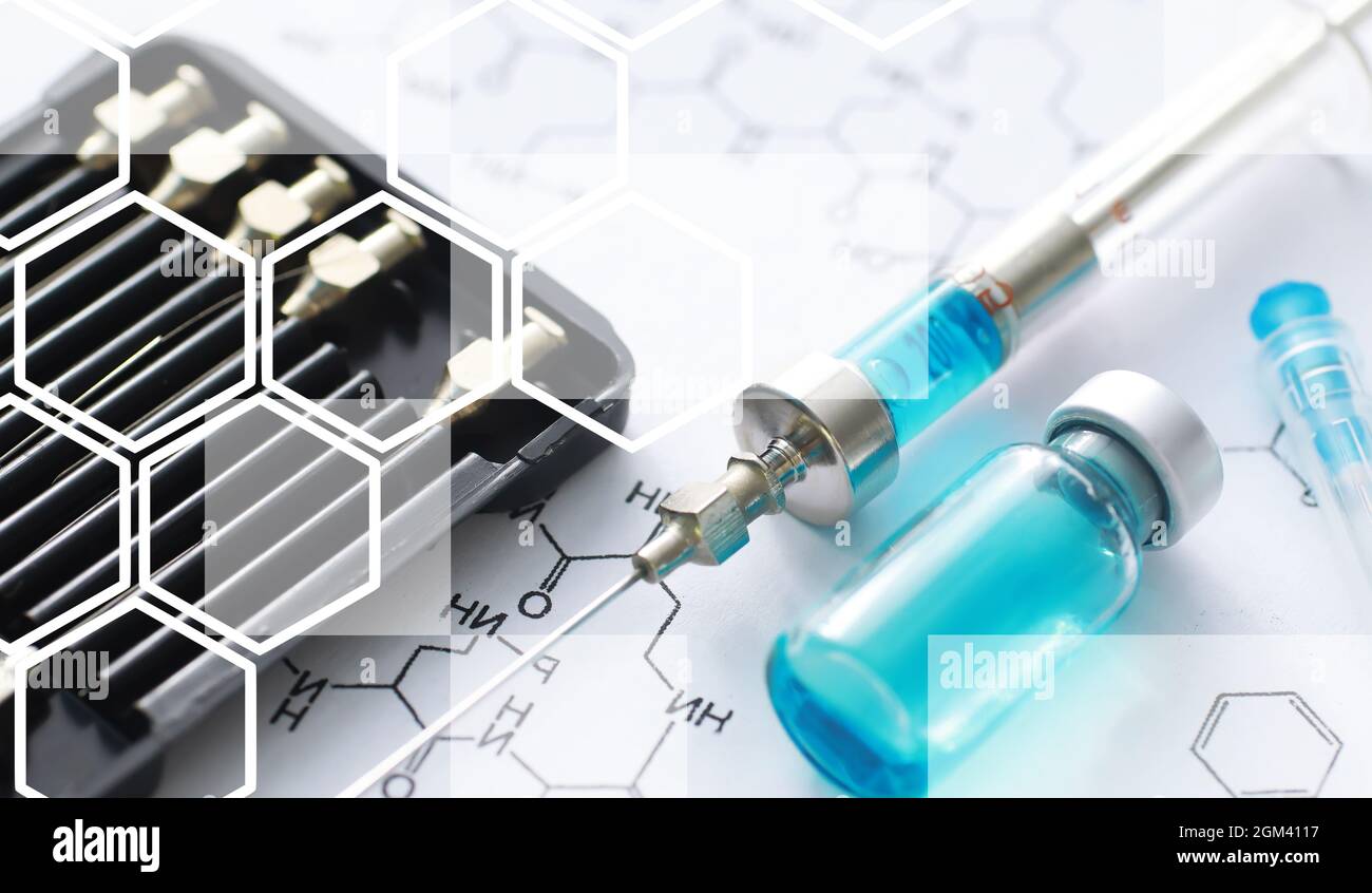 small jars with injection and syringe for injection on blue background ...