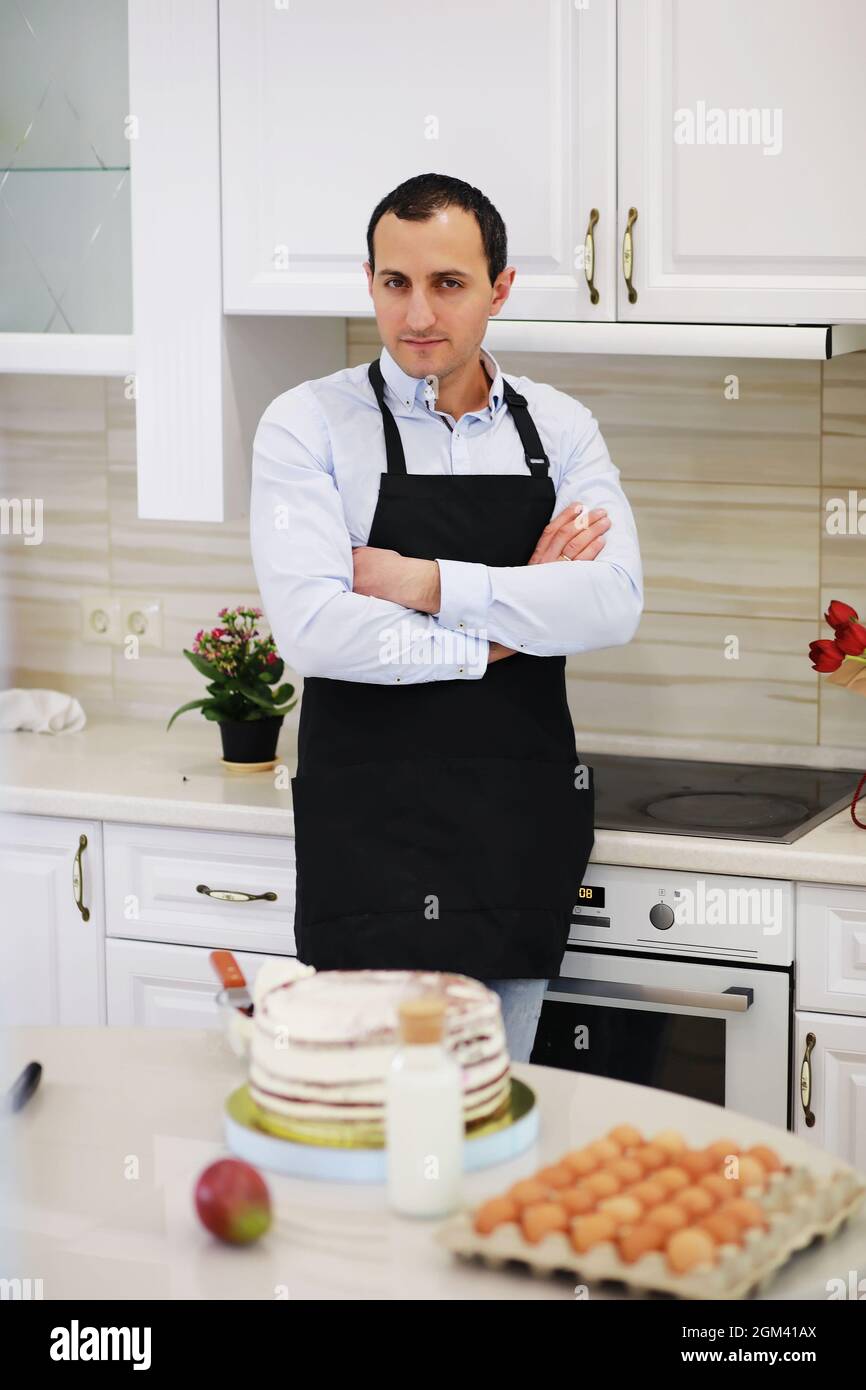 Master pastry chef in front of a desk. Cooking desserts at home. The ...