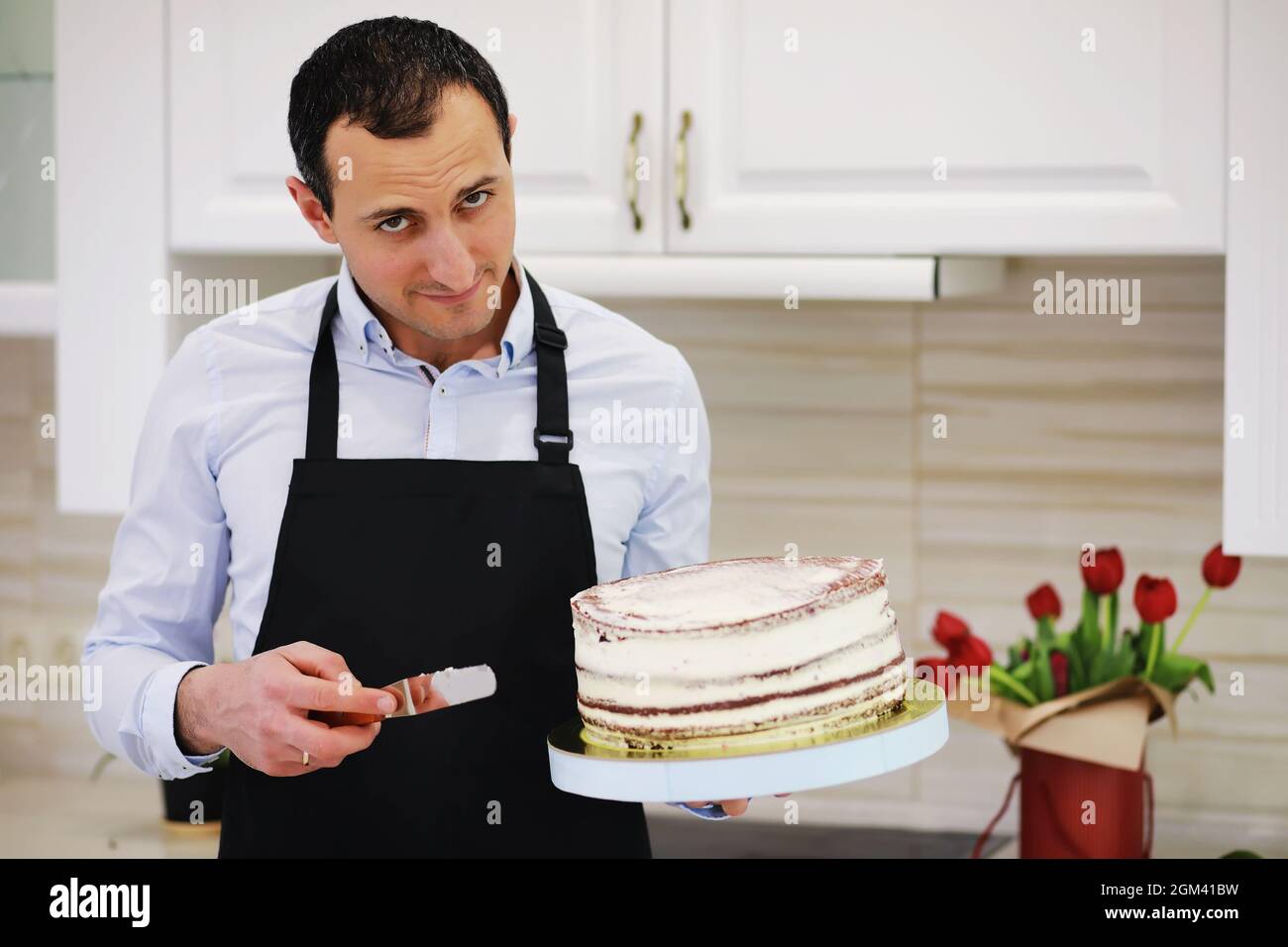 Master pastry chef in front of a desk. Cooking desserts at home. The ...