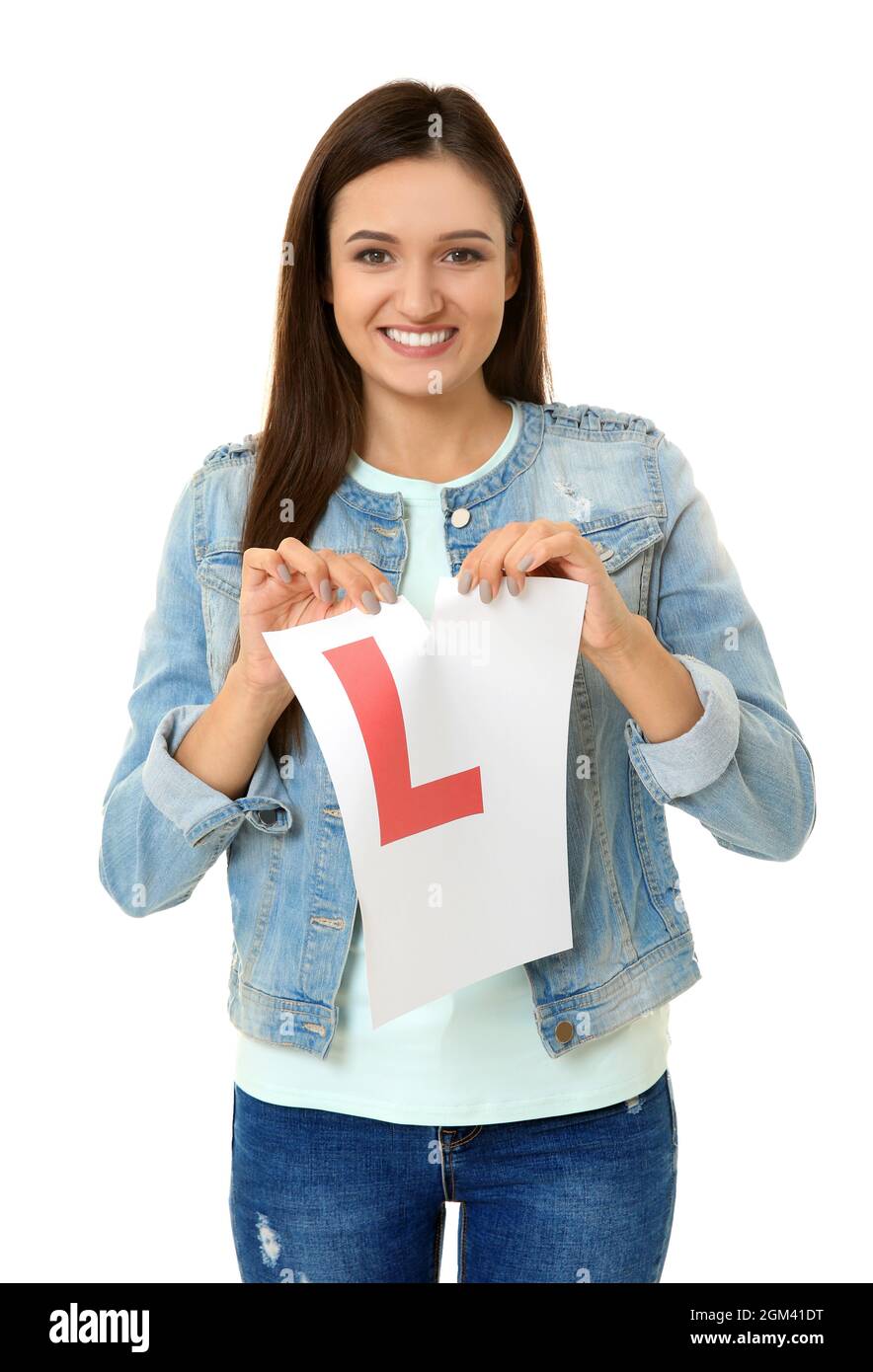 Young woman tearing learner driver sign on white background Stock Photo ...
