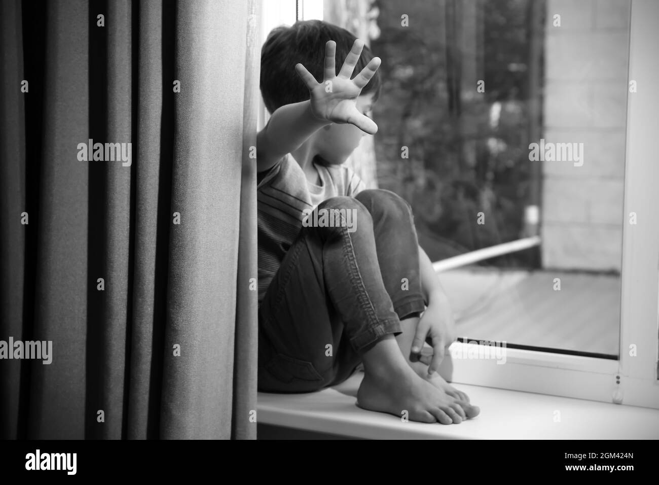 Helpless little boy near window. Abuse of children concept Stock Photo ...