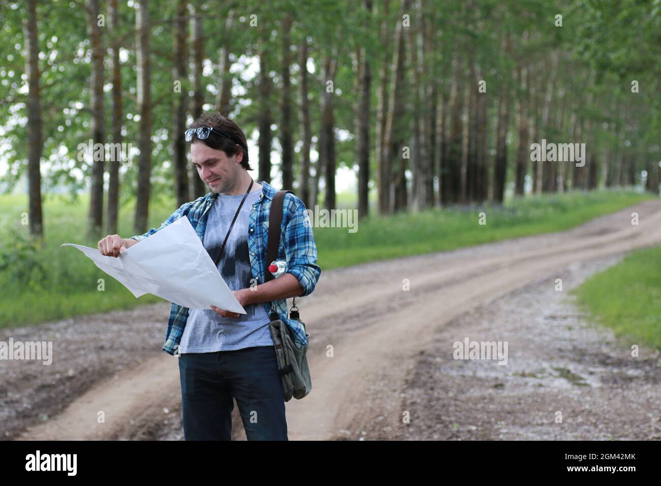 A young man looks at a map in the nature so as not to get lost Stock ...
