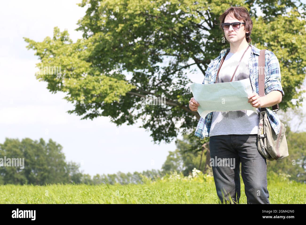 A young man looks at a map in the nature so as not to get lost Stock ...