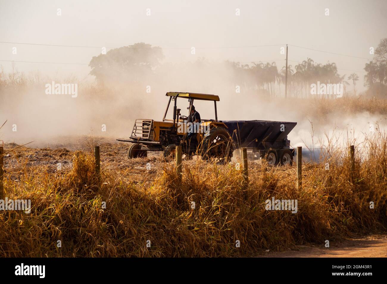 Machine working in the field. Tractor working in the field and raising ...