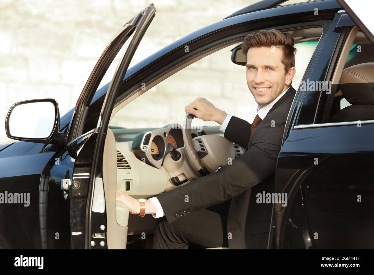 Man in formal wear getting out of car Stock Photo - Alamy